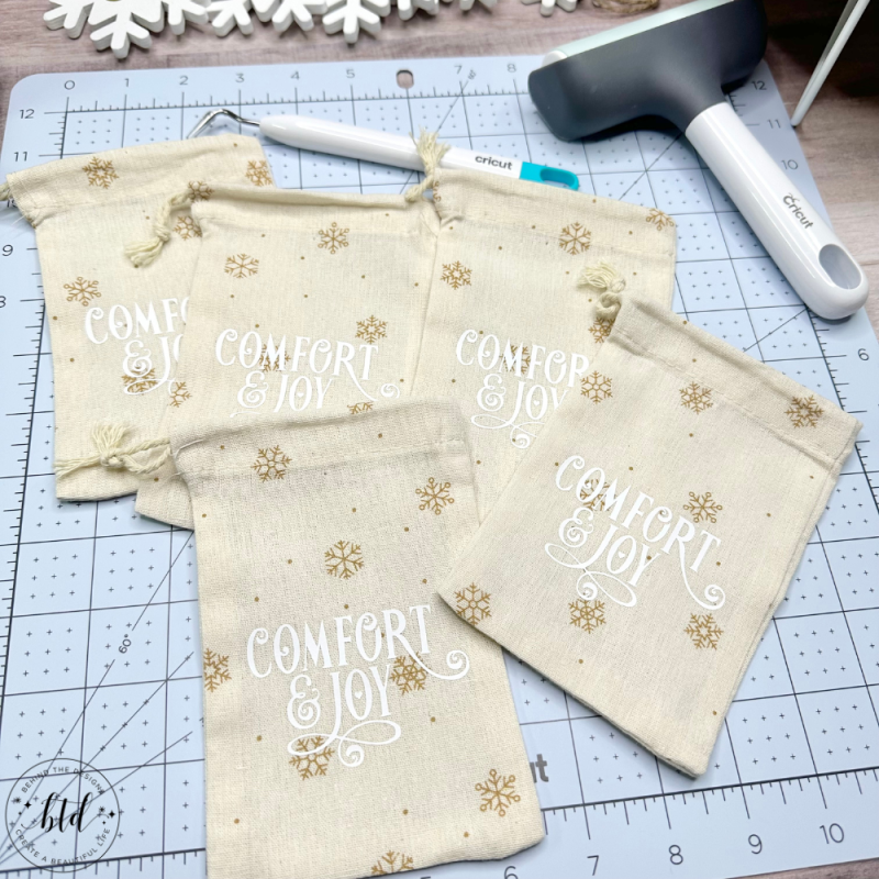 Comfort & Joy Snowflake Fabric Gift Pouch Using Cricut - Behind the Designs